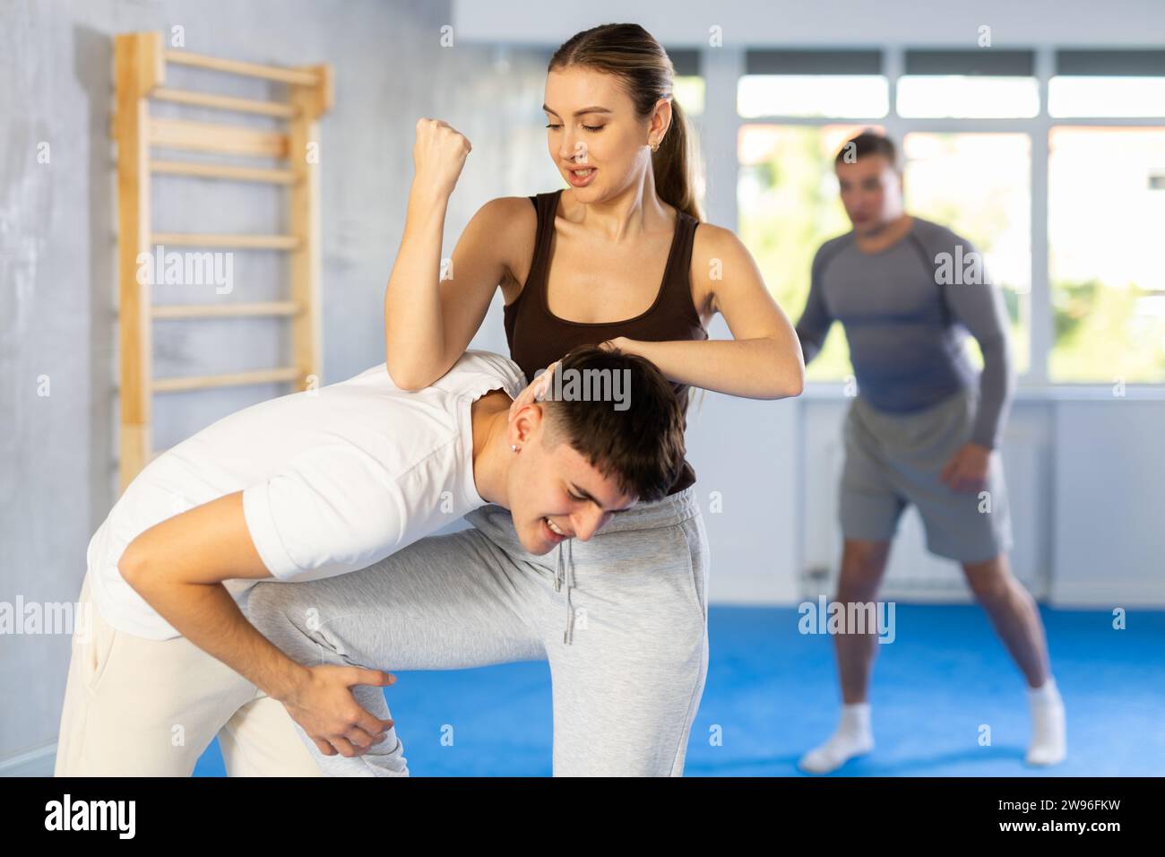 Self-defense lesson - woman learns to fight back an attacking man Stock ...