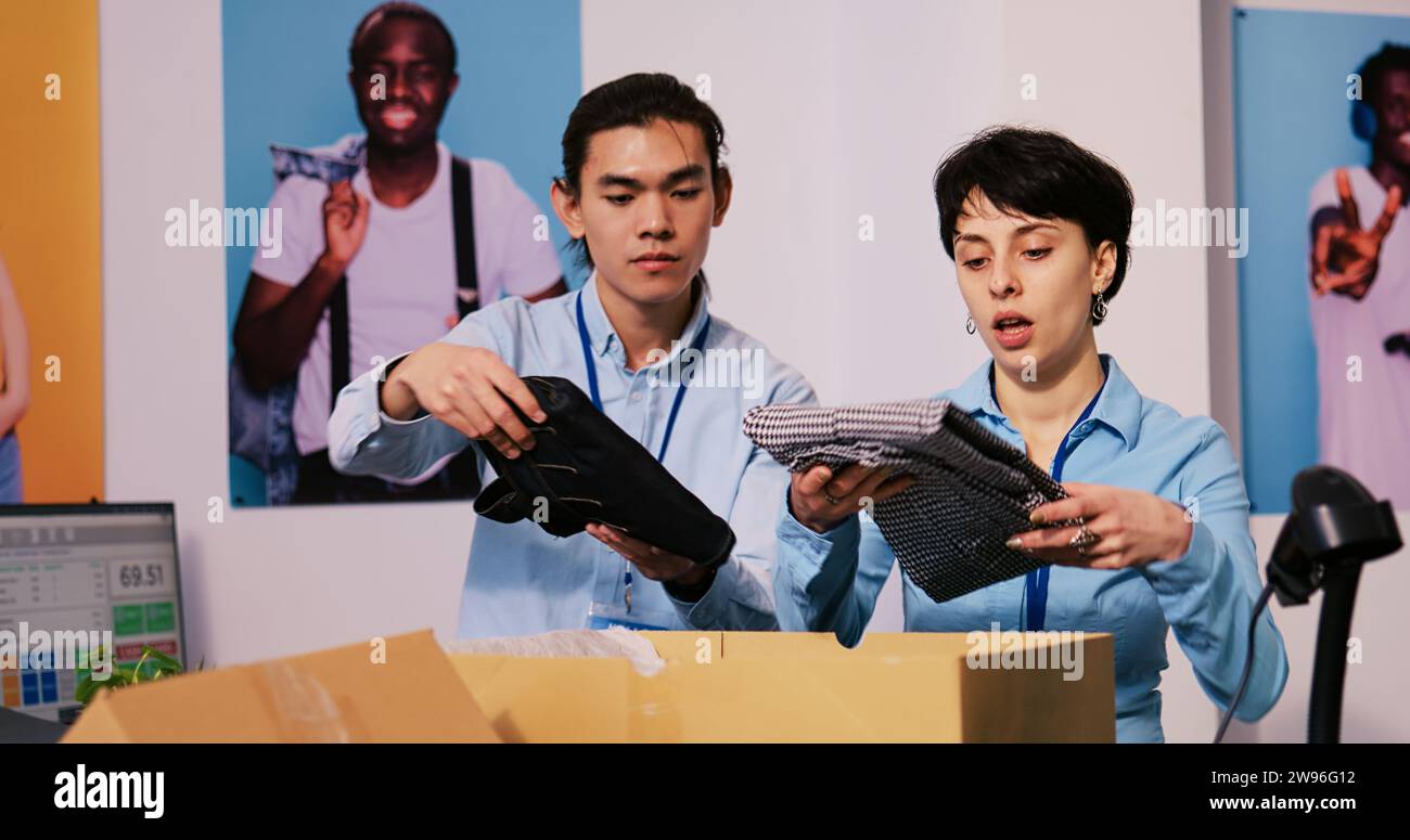 Diverse store managers preparing packages for shipping, putting stylish ...