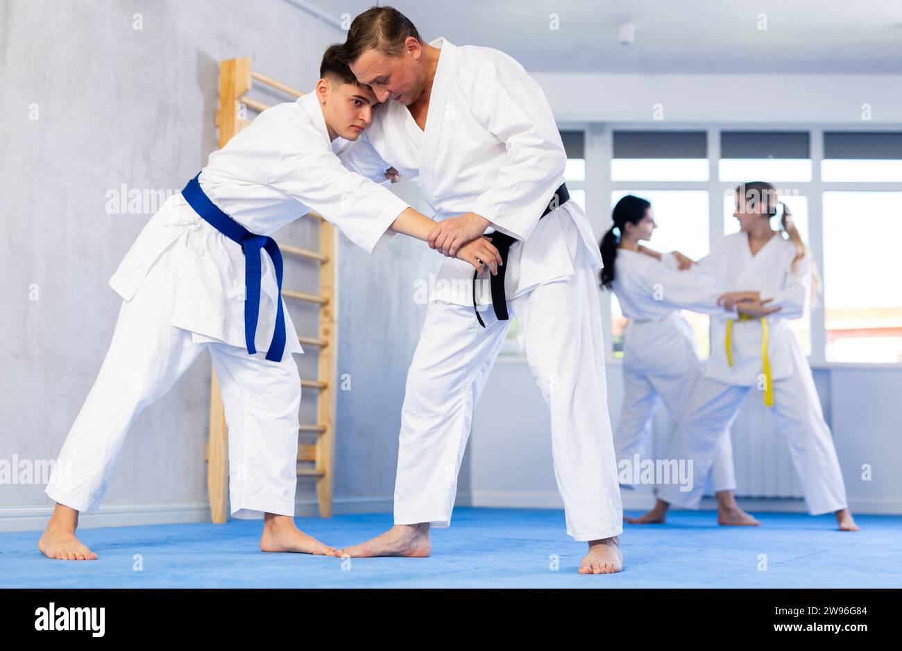 Practiced middle-aged and young male jujutsu practitioners ...