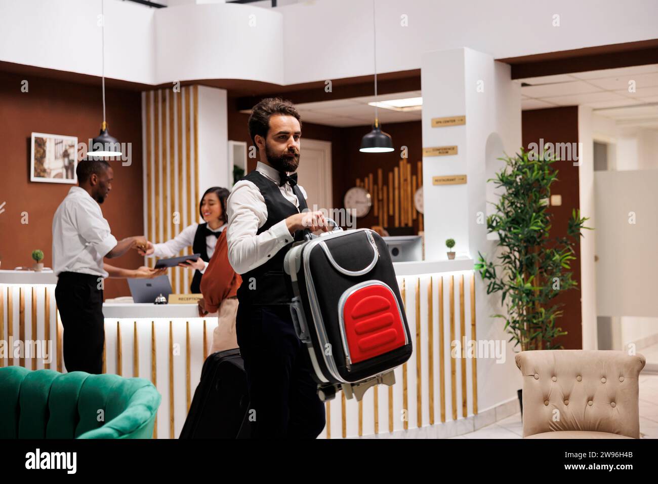 Hotel porter carrying luggage hi-res stock photography and images - Alamy
