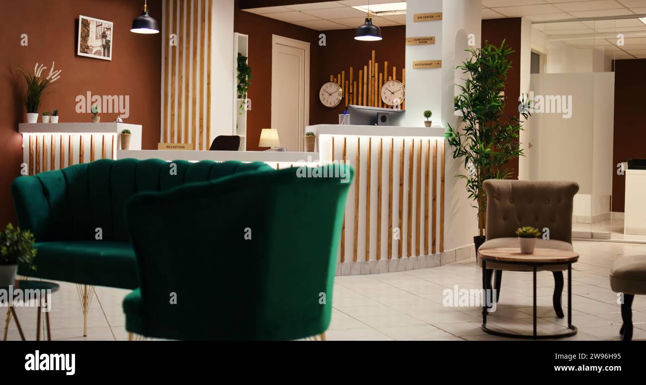 Wide angle crane shot of empty hotel foyer with check in front ...