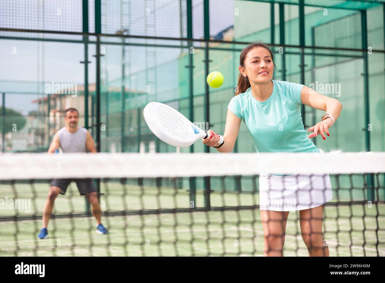 Portrait of emotional woman paddle tennis player during friendly ...