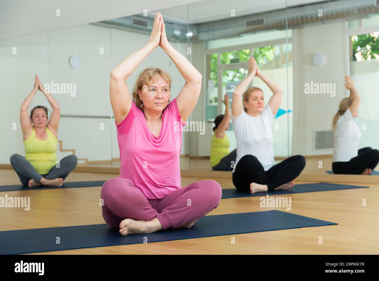 People studying new position at yoga modern school Stock Photo - Alamy