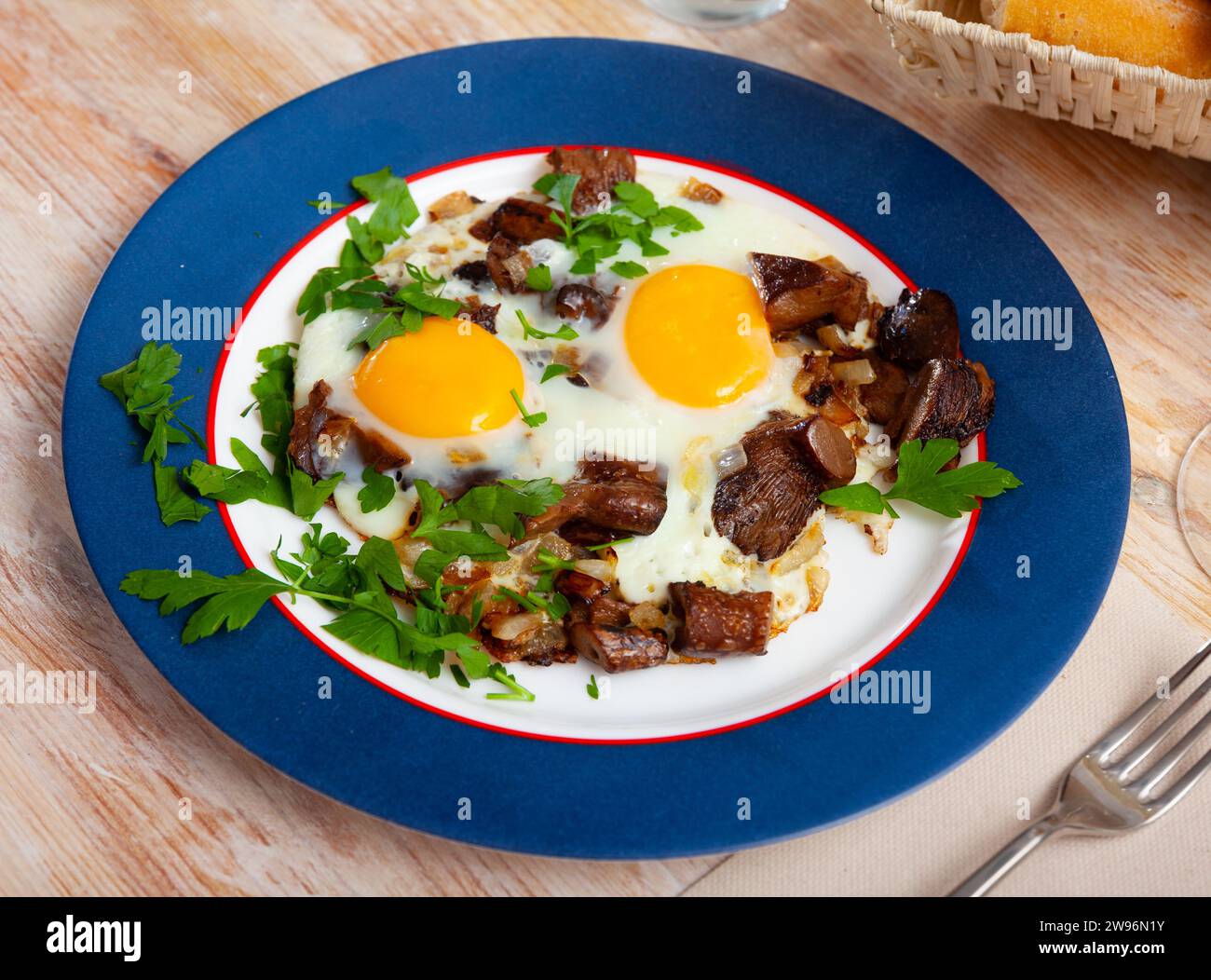 Tasty breakfast, fried eggs with saffron milk cap mushrooms and onion ...