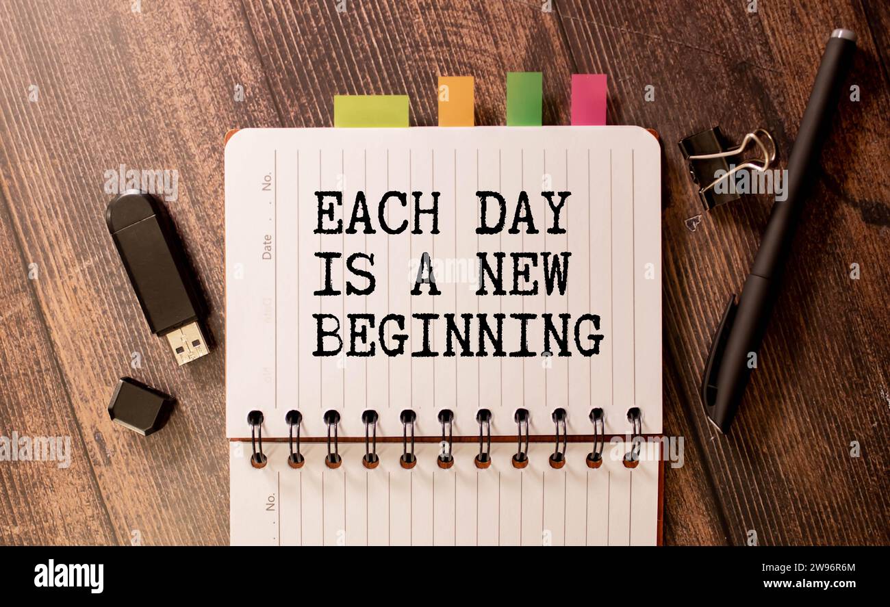 Each Day Is A New Beginning - text on a notepad with wrinkled paper and ...