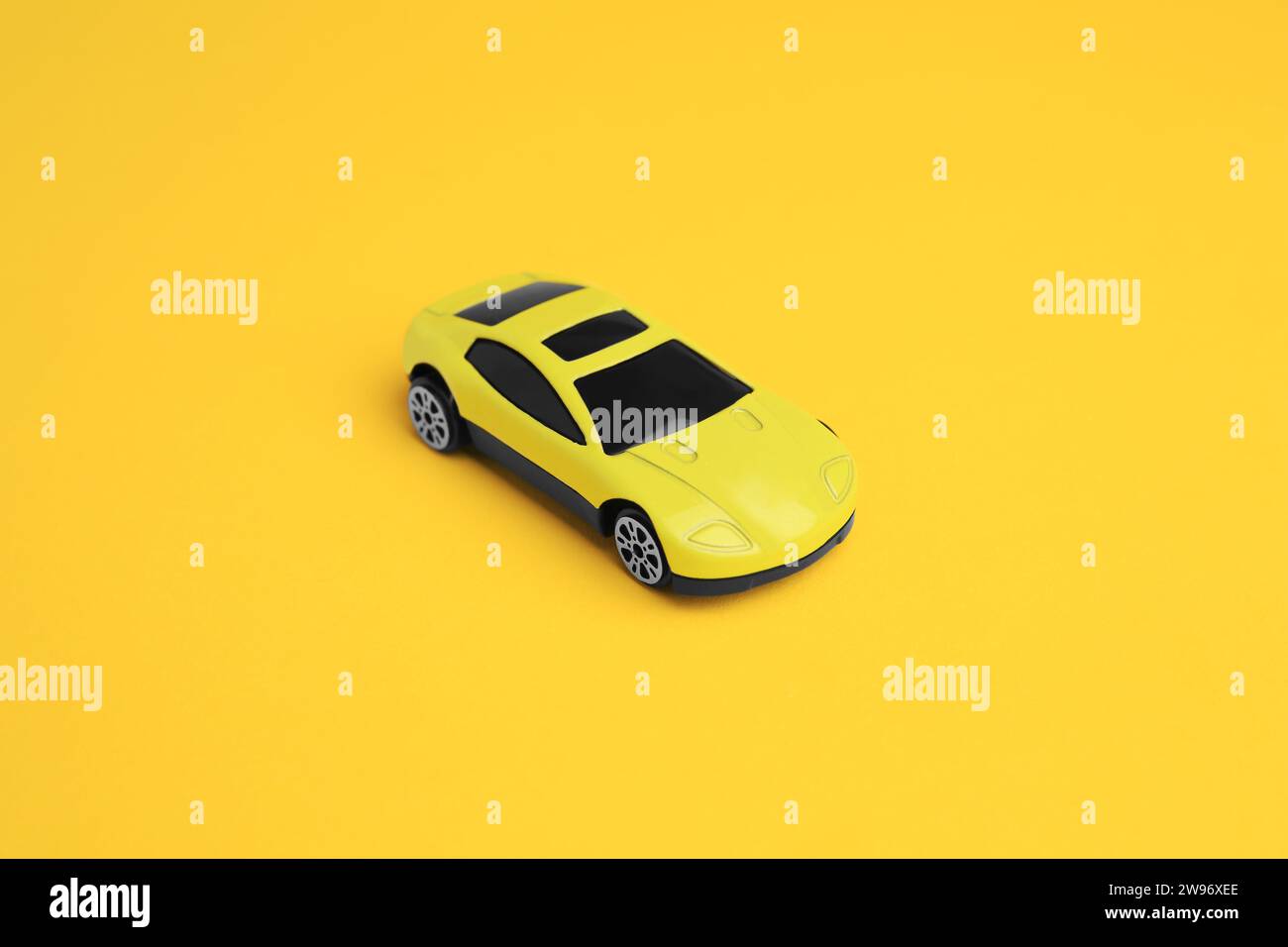 One bright car on yellow background. Children`s toy Stock Photo - Alamy
