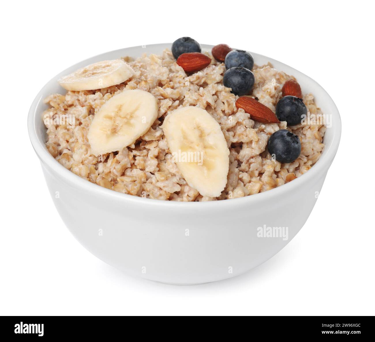 Tasty boiled oatmeal with banana, blueberries and almonds in bowl ...
