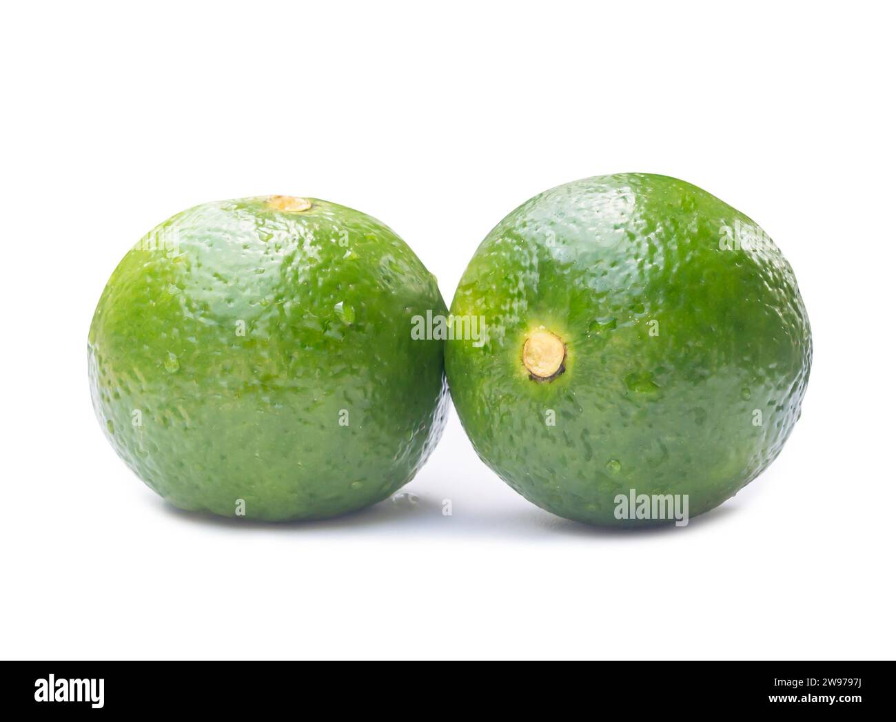 Two green lemon fruits with some drop on them are isolated on white ...