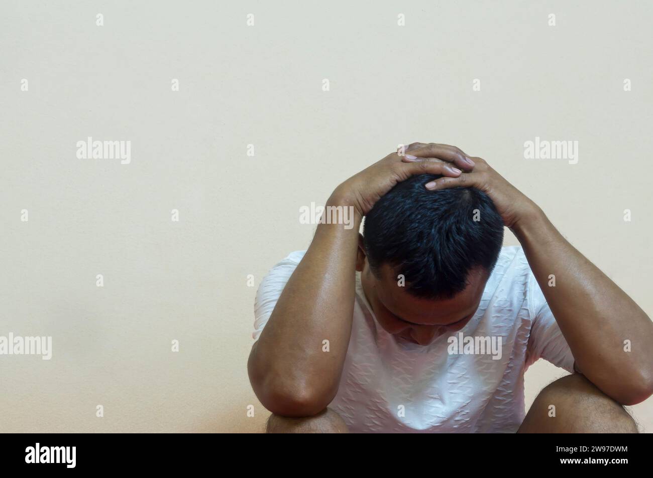 Man sitting head against hand hi-res stock photography and images - Alamy