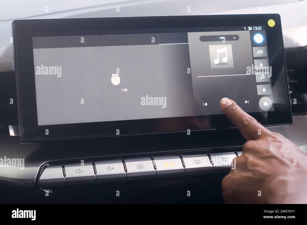 Close up photo, driiver's forefinger is touching flat screen player to ...