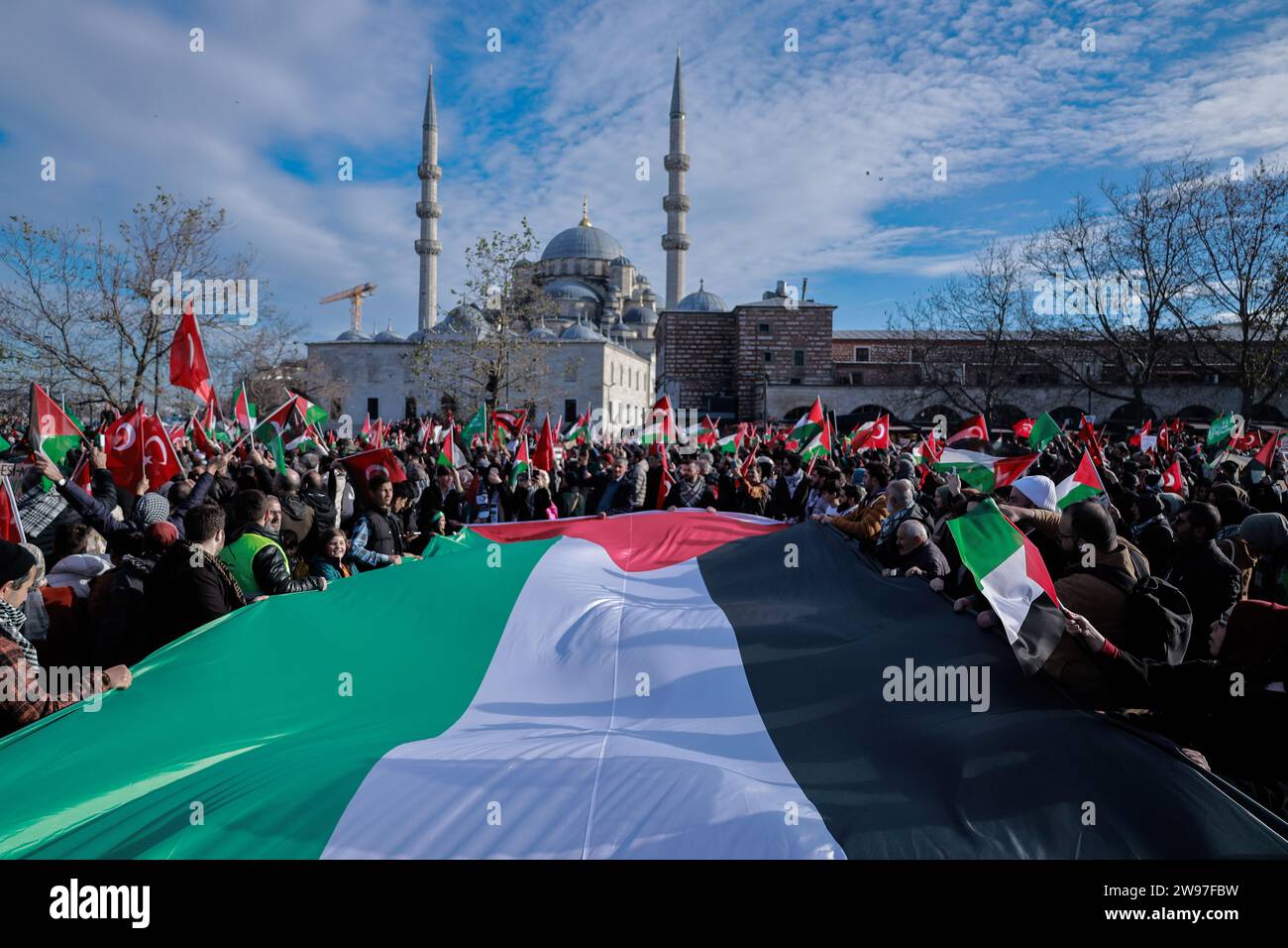 Istanbul, Turkey. 24th Dec, 2023. A group of Turkish people raise ...