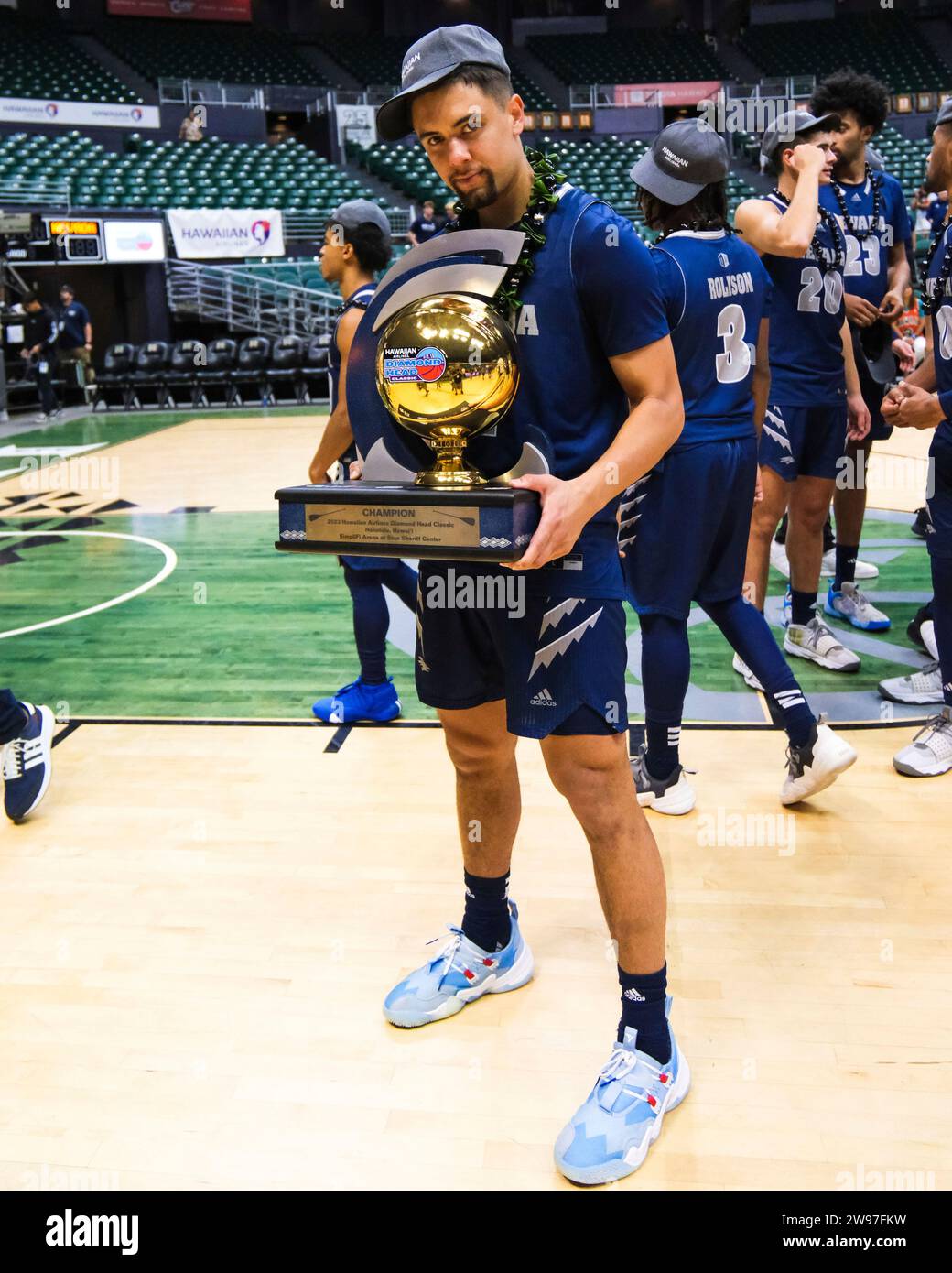 December 24, 2023: Nevada guard Jarod Lucas (2) poses with the trophy ...