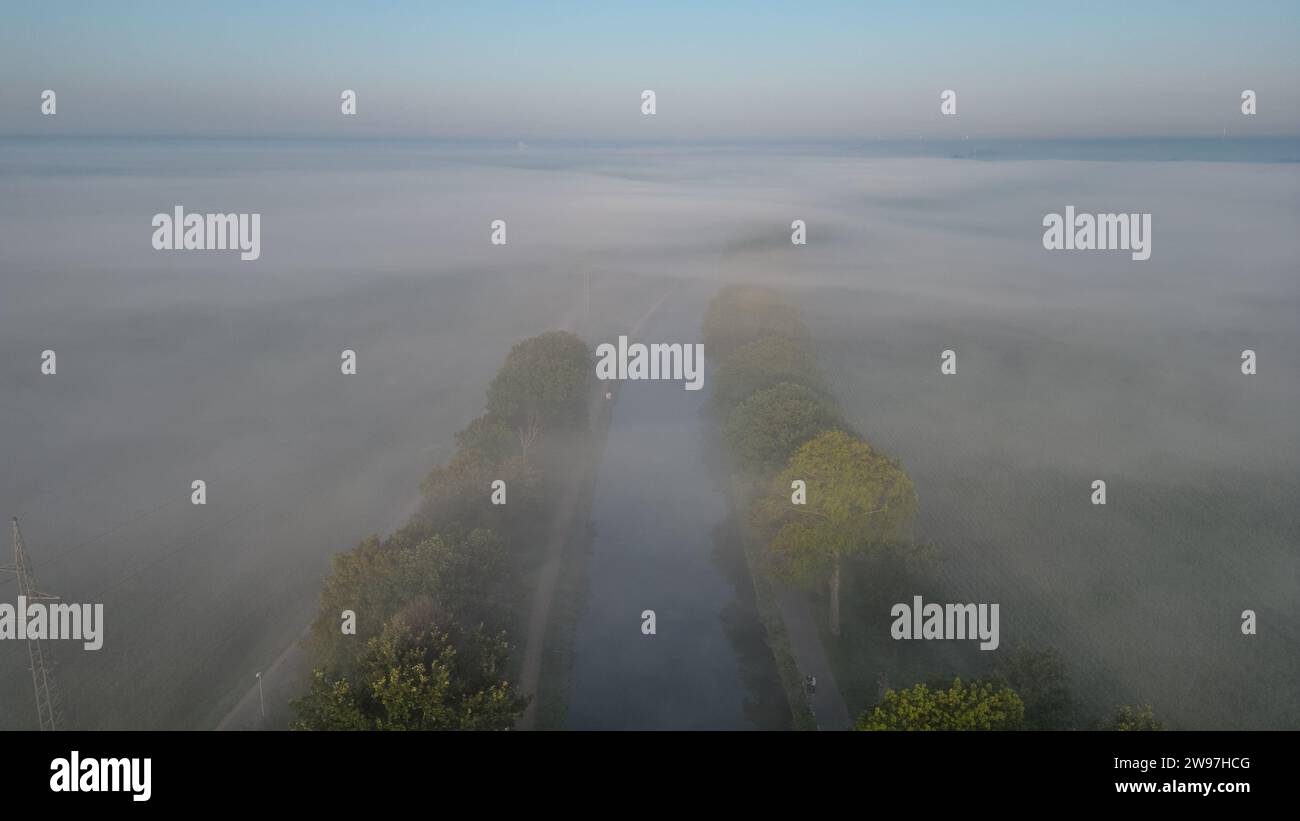 This serene image offers an aerial perspective of a country road ...