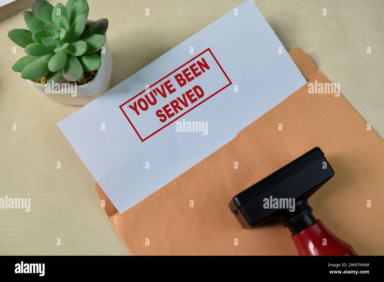 Red Handle Rubber Stamper and You've been served text above Brown ...