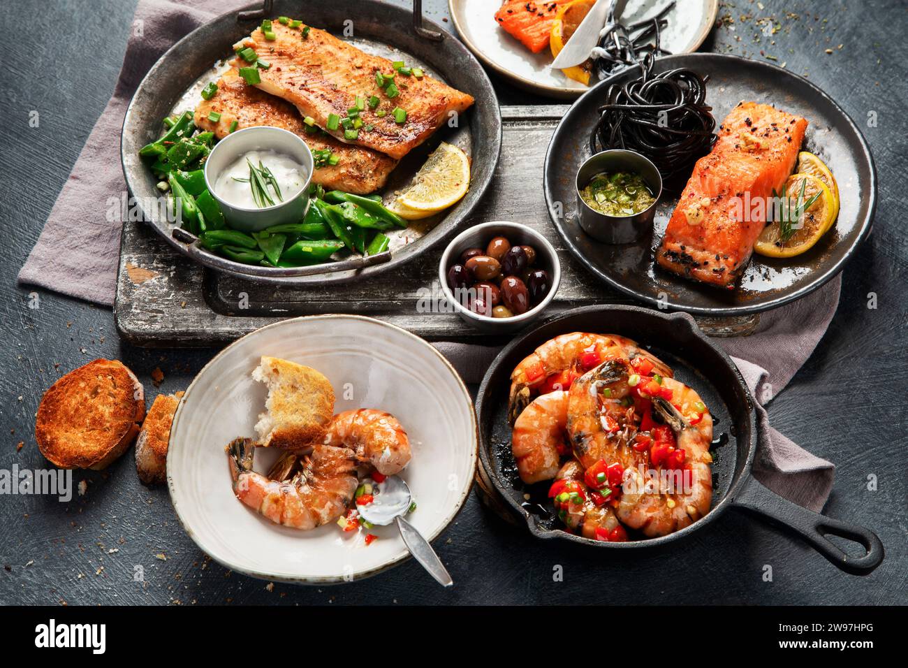 Grilled salmon fish fillet with lemon and strimps. Sea food dishes ...