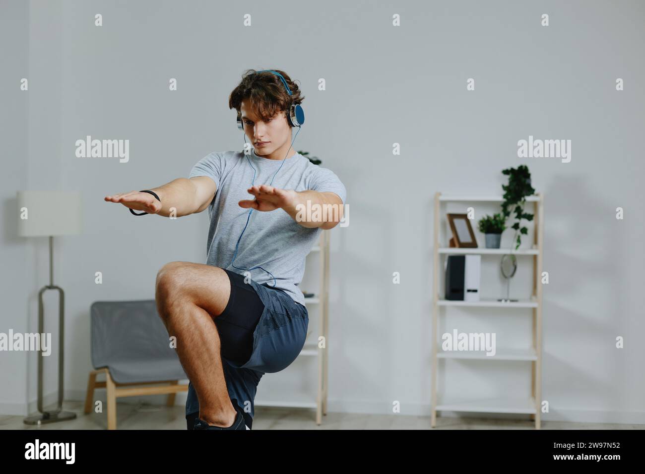 indoor man home lifestyle workout healthy activity gray sport headphone ...