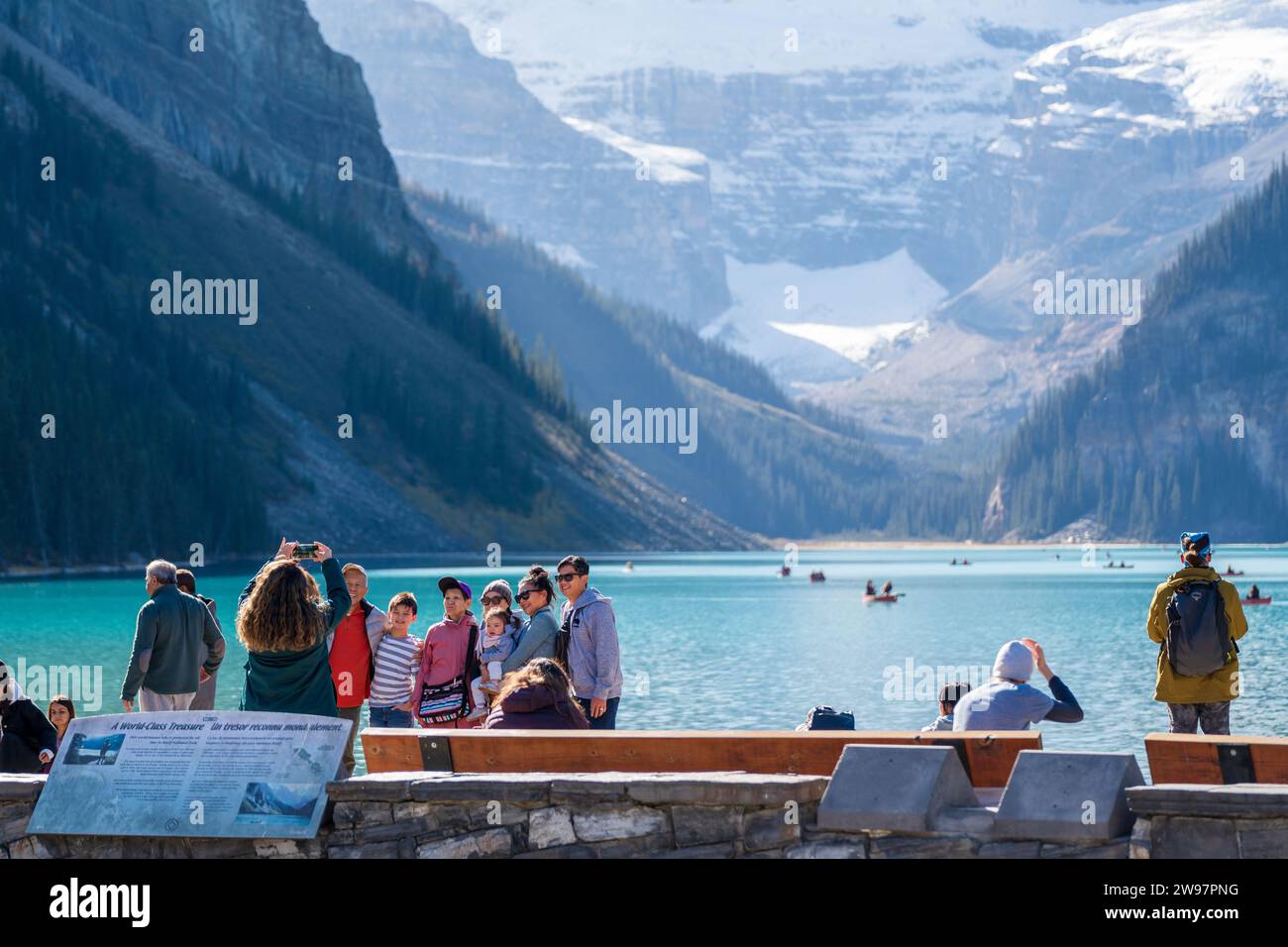 Tourists taking commemorative photo on the Lake Louise lakeshore. Banff ...