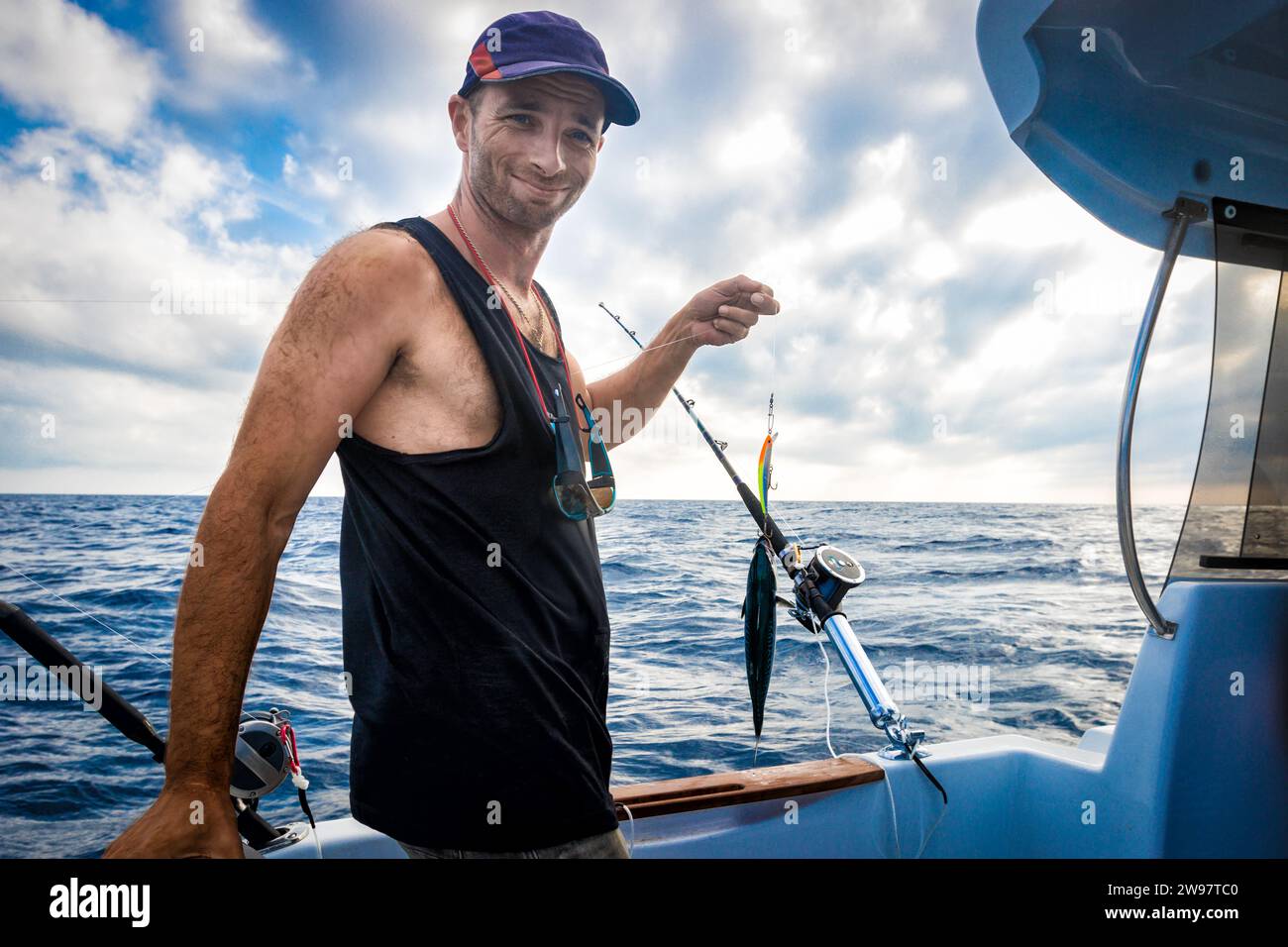 The young man in a baseball cap onboard the vessel in the course of ...
