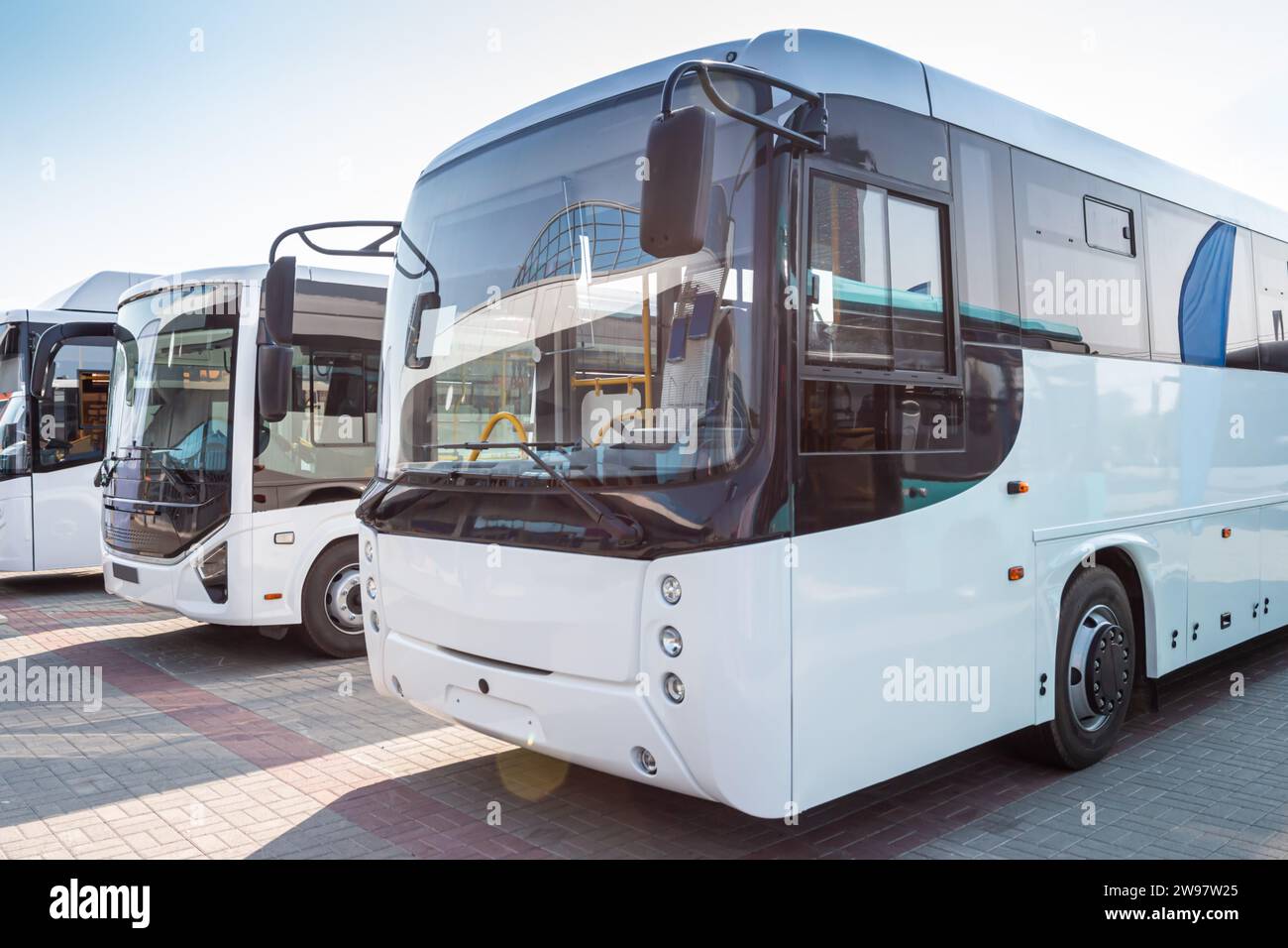 Modern white city buses at the bus station Stock Photo - Alamy