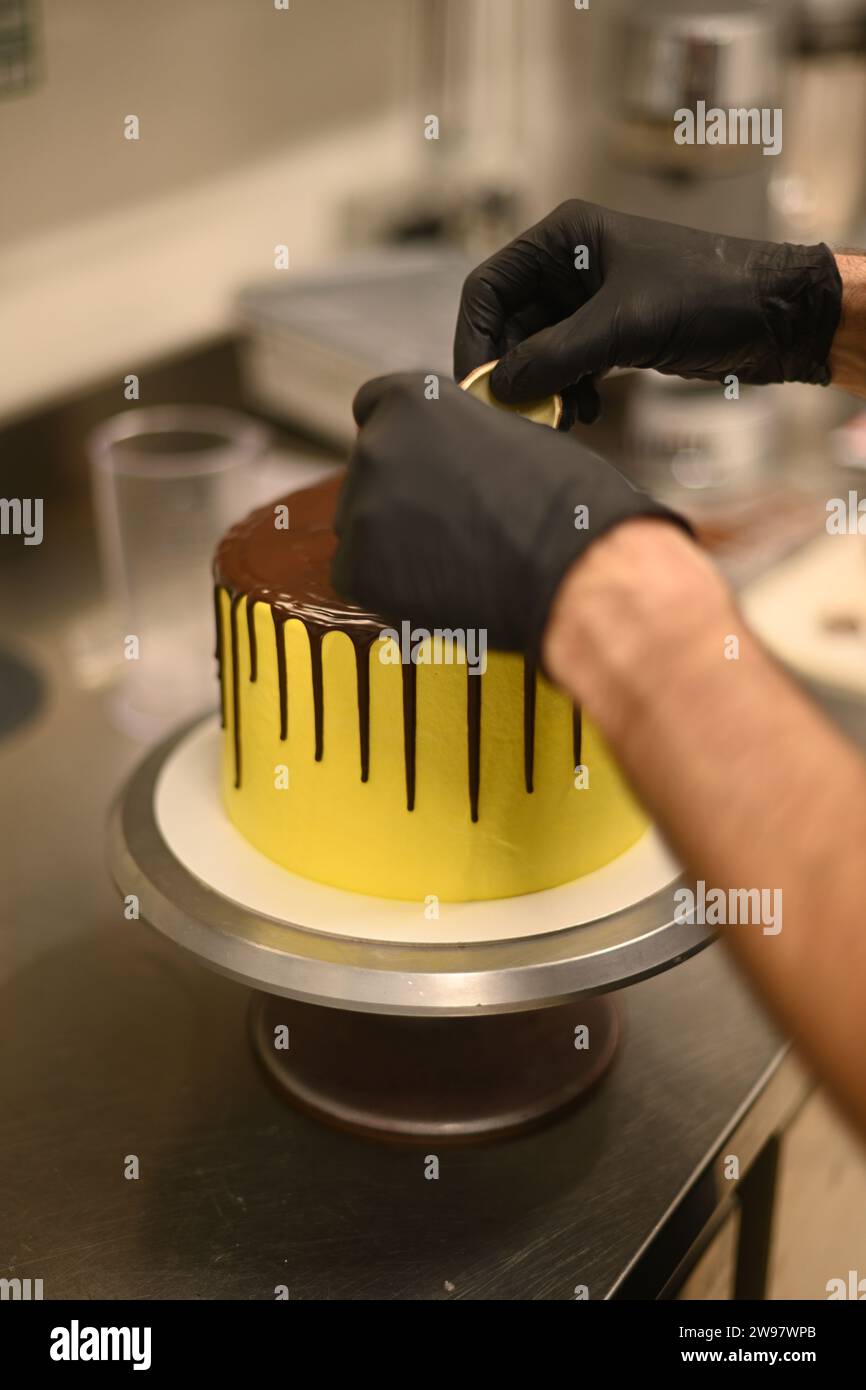 pastry chef smooth prepare sculpt yellow dripping frosted layered dark ...
