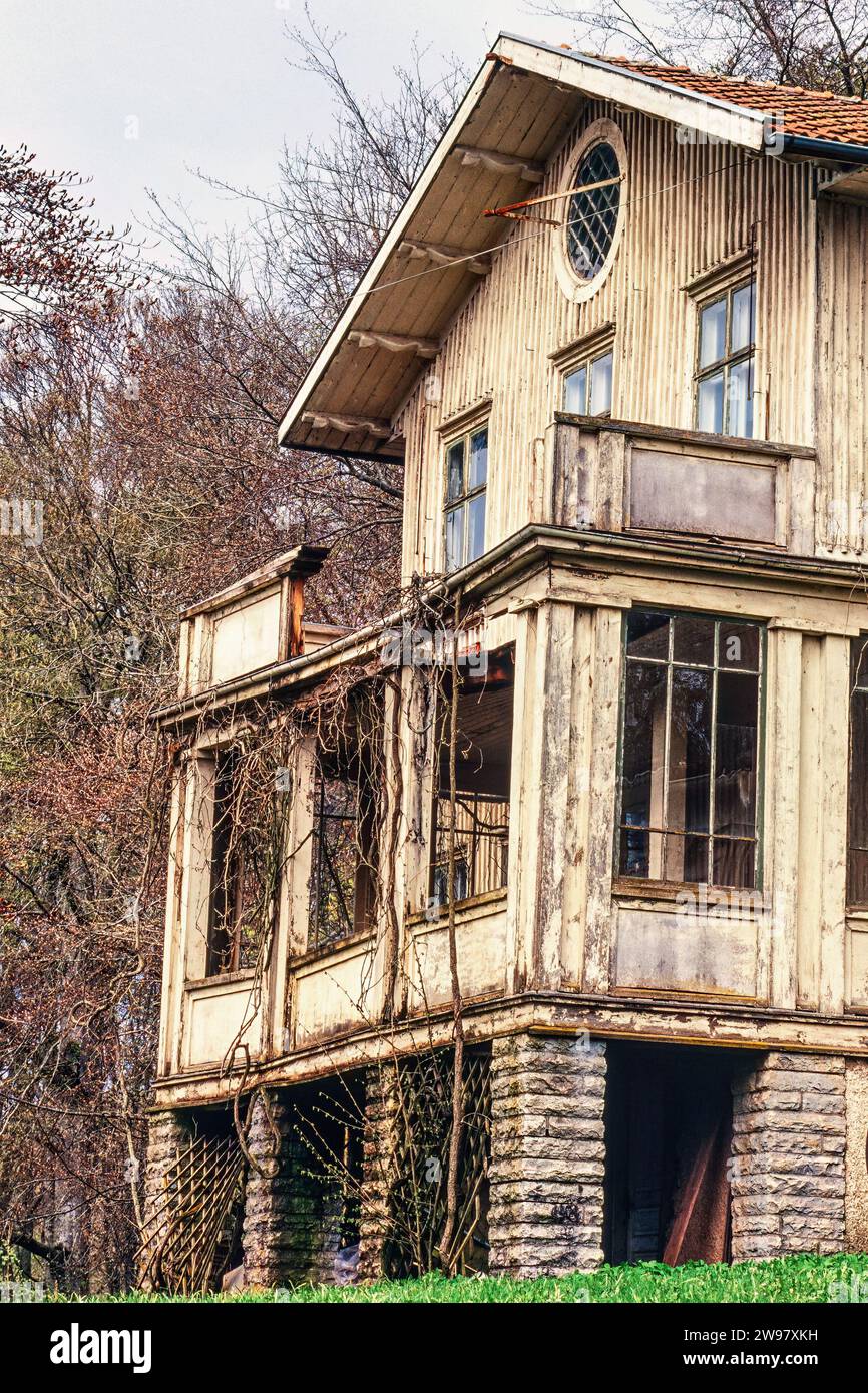 Beautiful old wooden house with a veranda in bad condition Stock Photo ...