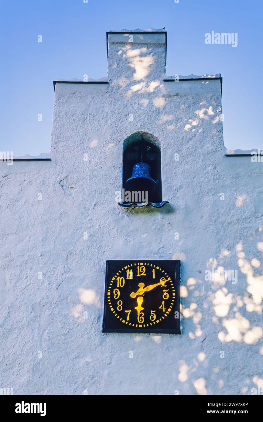 Crow-stepped gable on a church with a bell and a clock Stock Photo - Alamy
