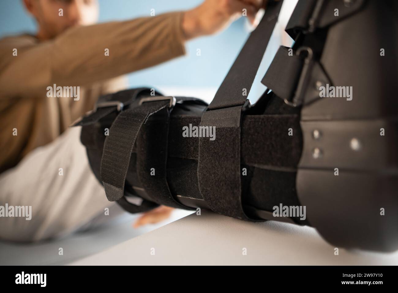 Close-up of a man putting on a black brace for a broken ankle. Ankle injury tendon support Stock ...