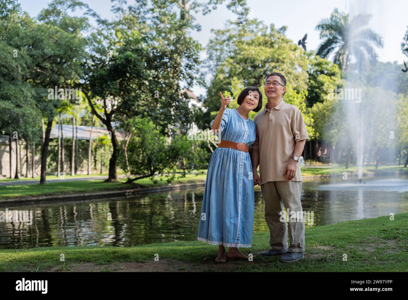 Happy active senior couple having fun outdoors in a park. Portrait of ...