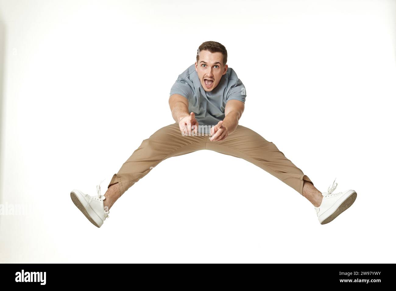 happy guy looking pointing at the camera on white studio background ...