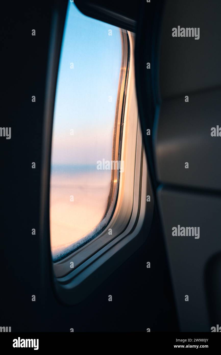 A window view looking out to the sky from an airplane as it flies ...
