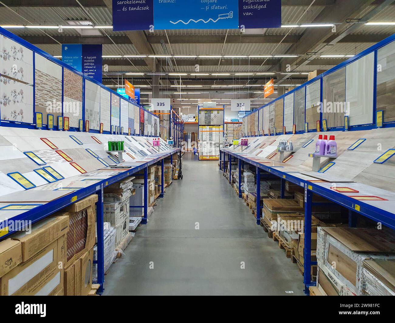 An interior image of a store aisle with multiple shelves Stock Photo ...