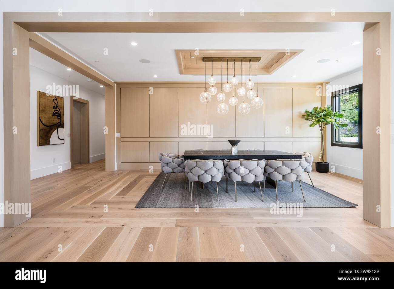 This modern dining room boasts a large window that overlooks the living ...