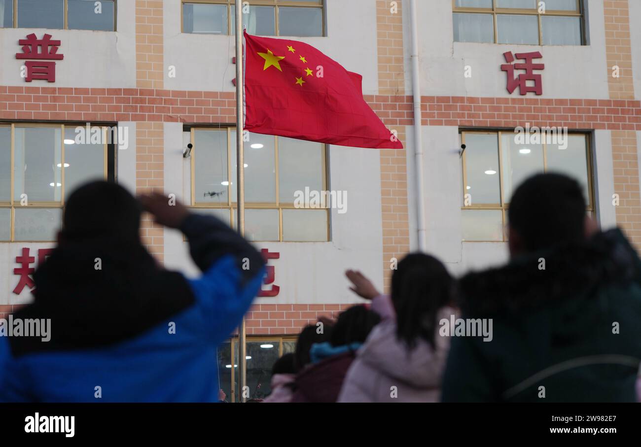 Jishishan, China's Gansu Province. 25th Dec, 2023. A flag-raising ...