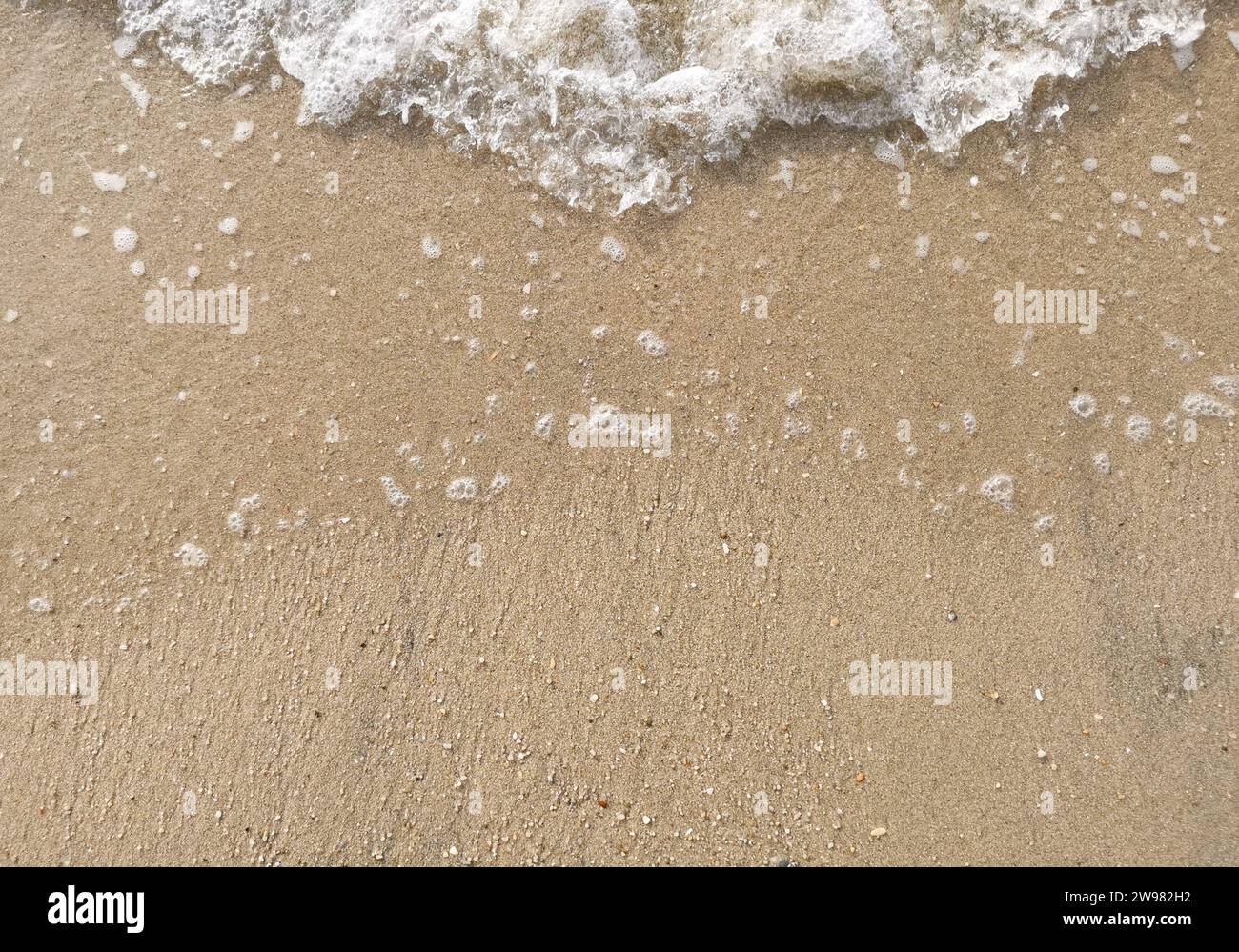 Waves on sandy beach bubble hi-res stock photography and images - Alamy