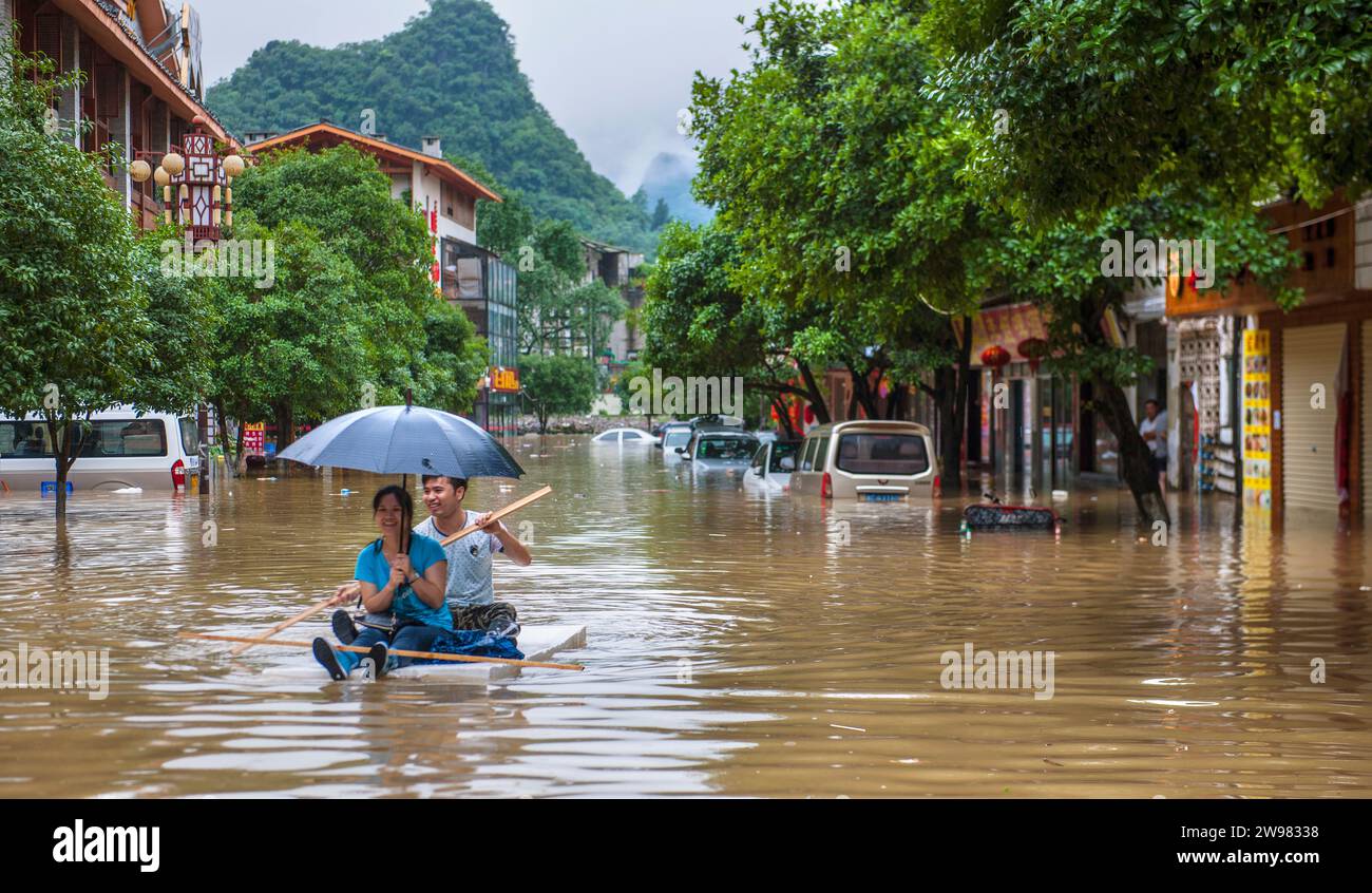 Couple Floating On A Raft During The Floods In Yangshuo Stock Photo - Alamy