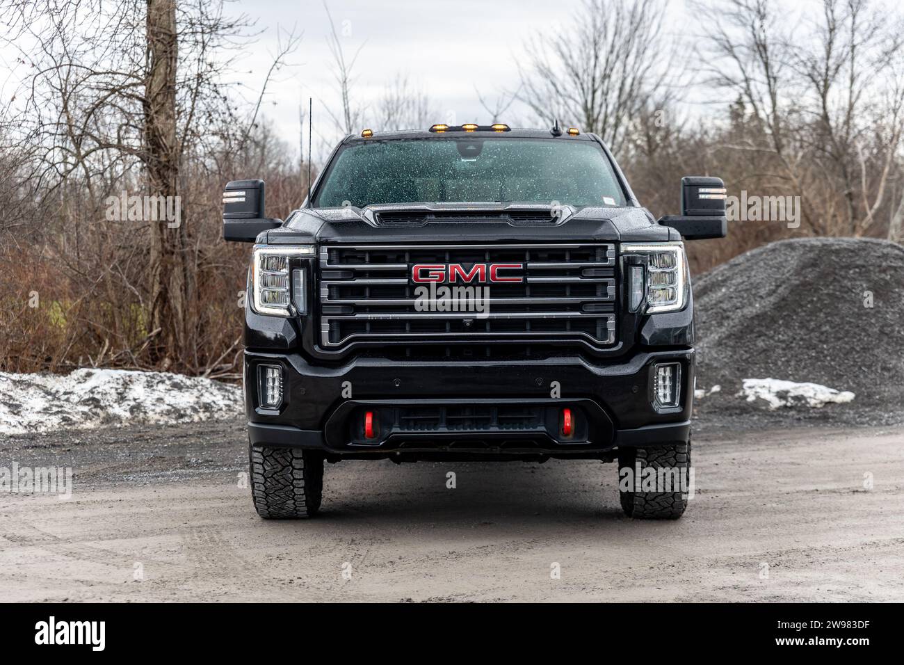 A black GMC truck in a parking area surrounded by trees Stock Photo - Alamy