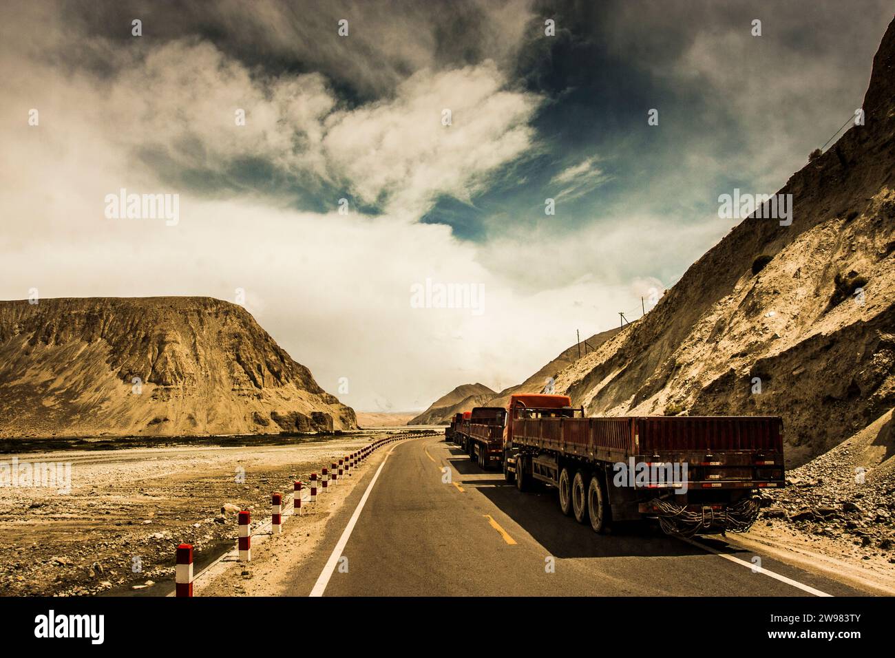 Trucks stopped along a mountain road Stock Photo - Alamy