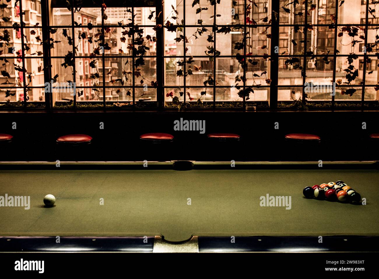 Billiards table overlooking a dense city Stock Photo - Alamy
