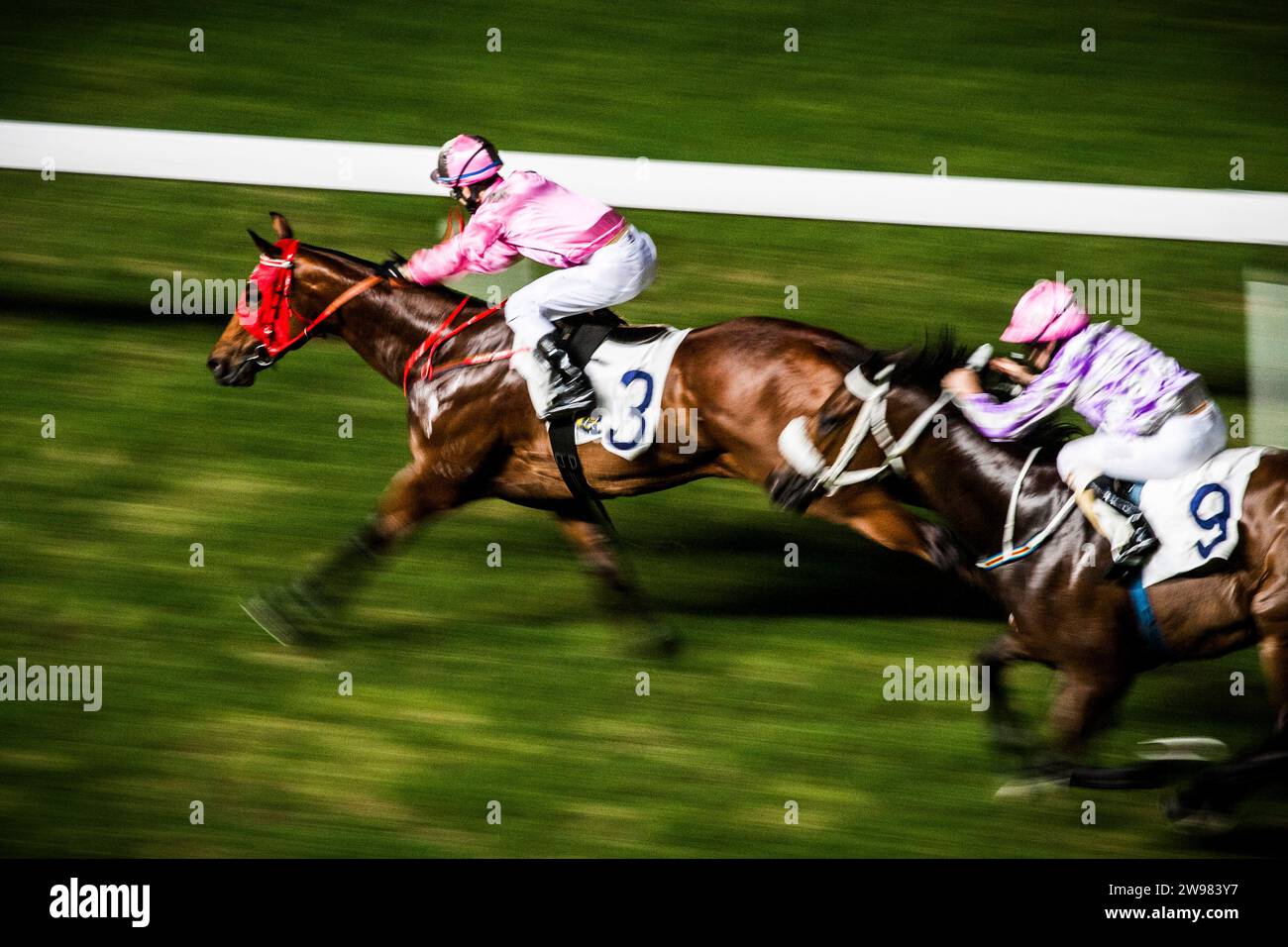 Jockey pulling into the lead at a horse race Stock Photo - Alamy
