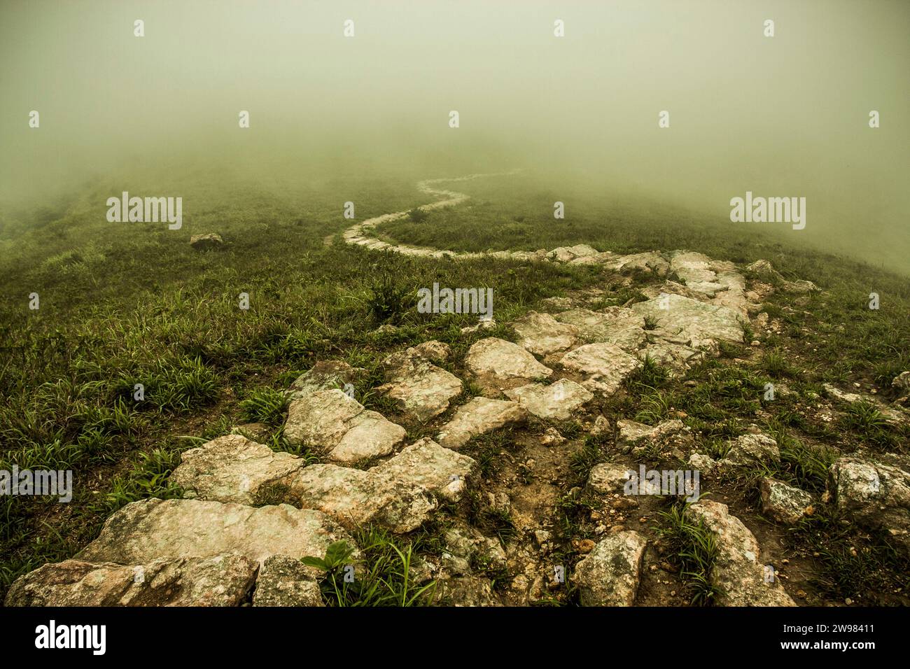 Steep stone path down a misty mountain side Stock Photo - Alamy