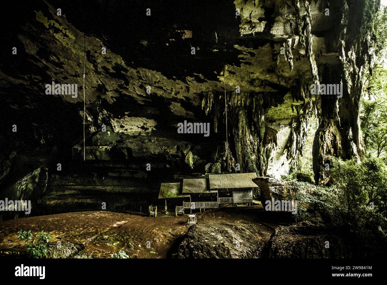 Wide opening and small house in a cave Stock Photo - Alamy