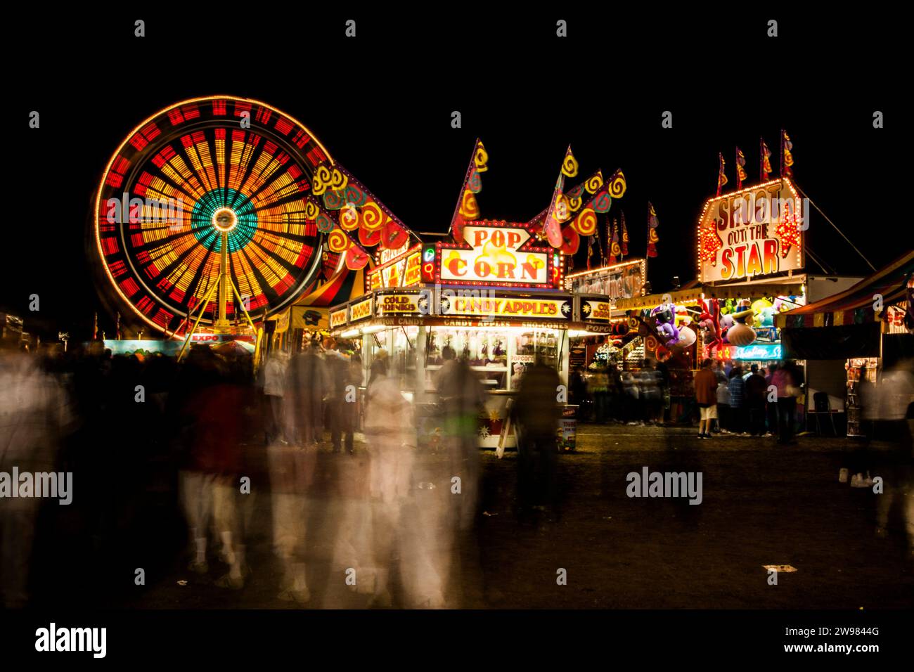 Ferris wheel and carnival scene at night Stock Photo - Alamy