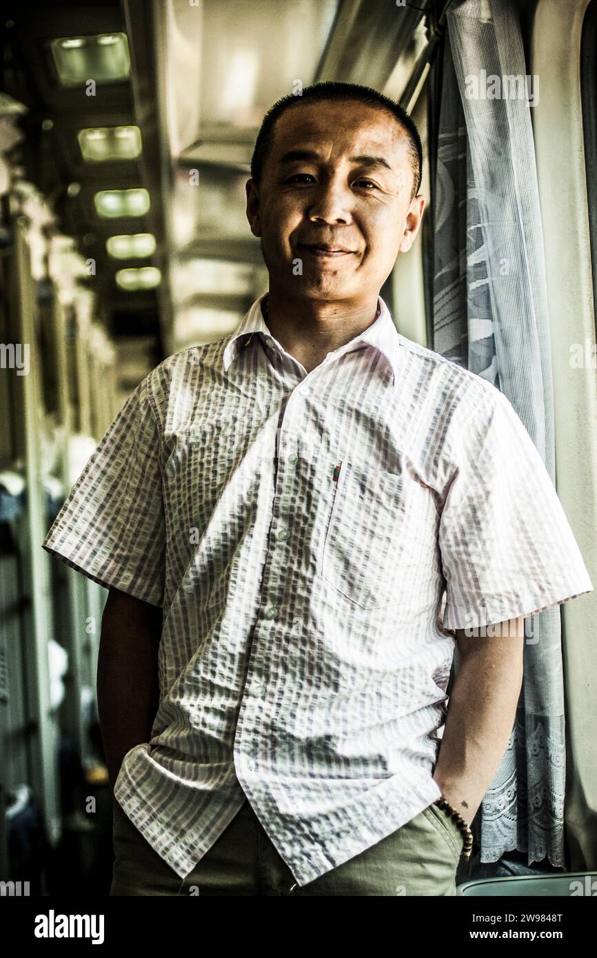 Portrait of a man on a train in China Stock Photo - Alamy