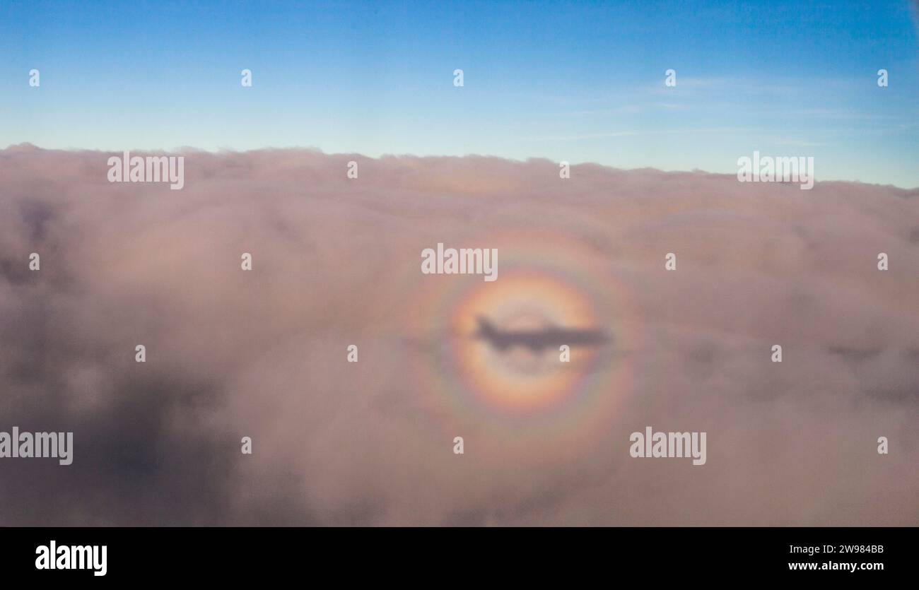 Circular rainbow with airplane shadow Stock Photo - Alamy