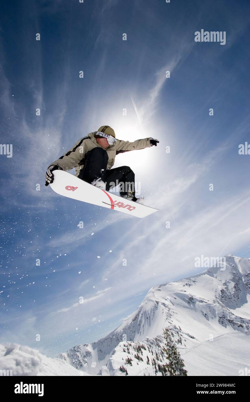 A snowboarder jumping of a cliff at Snowbird, Utah Stock Photo - Alamy