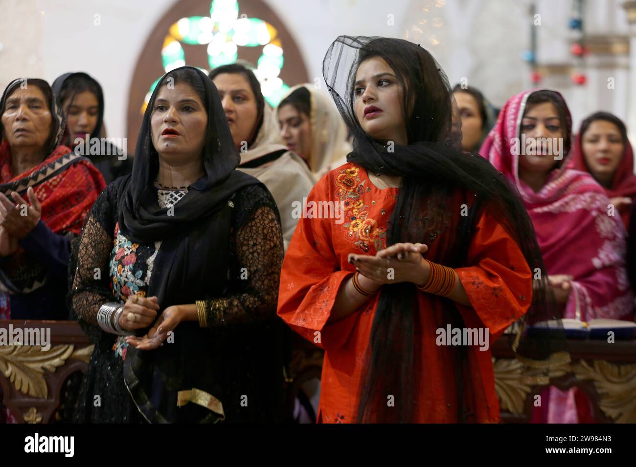Christians attend the Christmas Mass at the St. John's Cathedral, in Peshawar, Pakistan, Monday ...