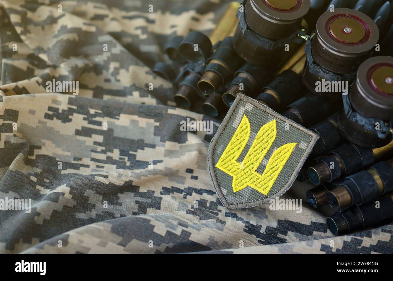 Ukrainian army symbol on machine gun belt lies on ukrainian pixeled ...