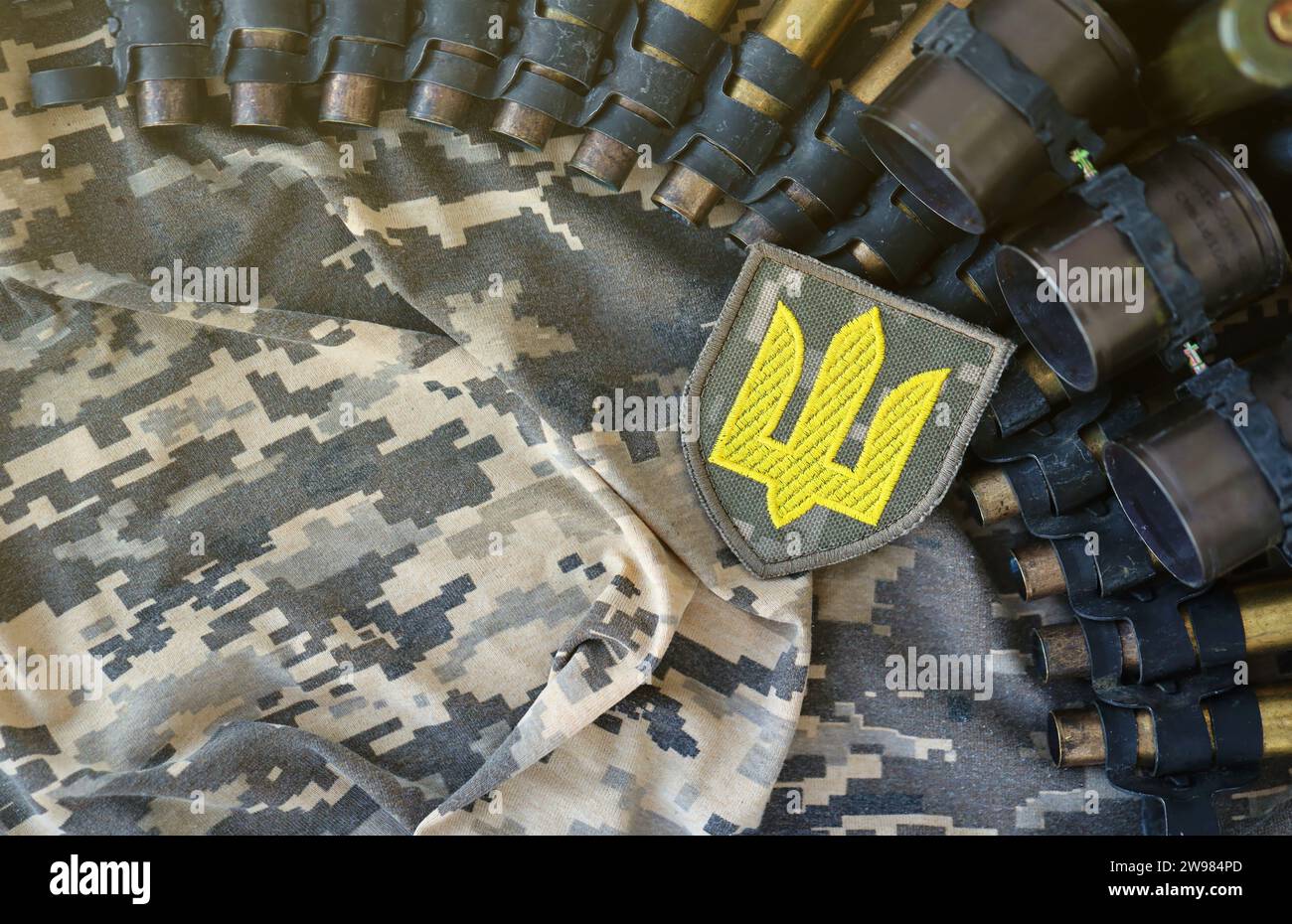 Ukrainian army symbol on machine gun belt lies on ukrainian pixeled ...
