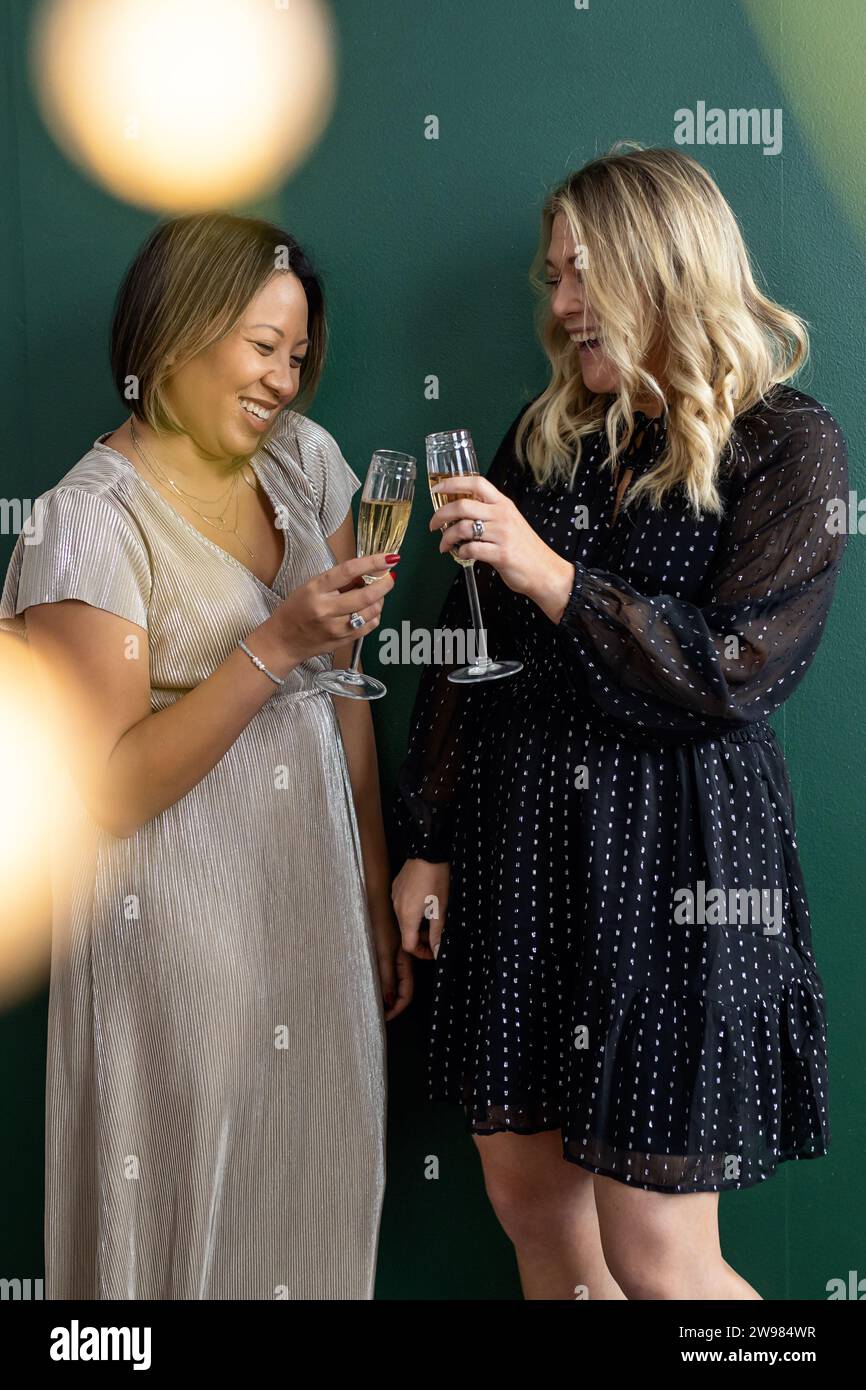 Two women dressed up fancy toasting with champagne flutes Stock Photo ...