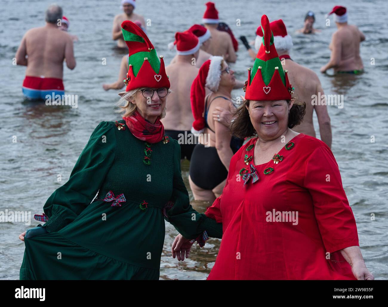 Berlin, Germany. 25th Dec, 2023. Two participants dressed as elves ...
